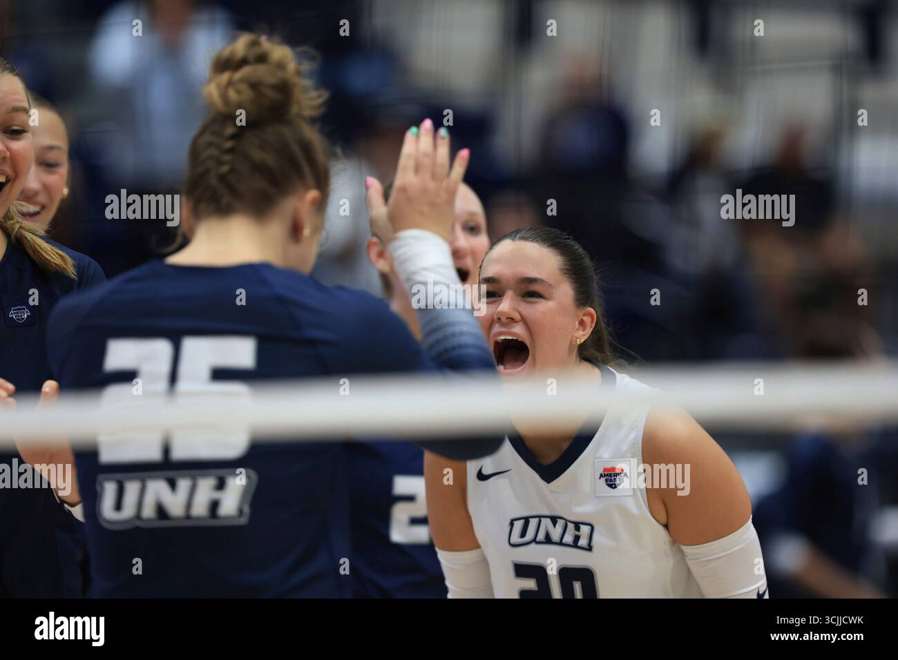 New Hampshire's libero Avery LePore, right, reacts during an NCAA college volleyball game ...