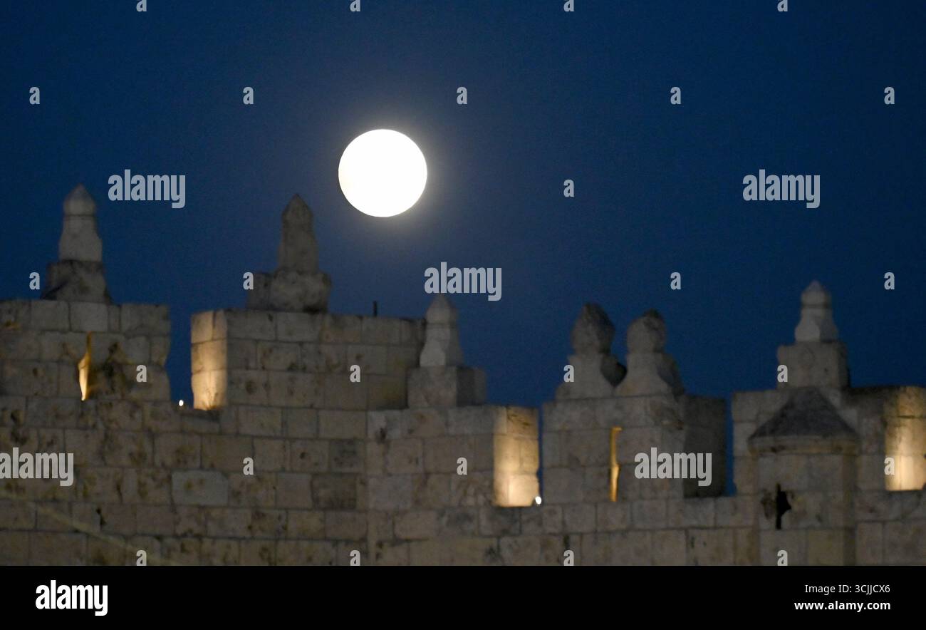 The moon is seen over the Old City of Jerusalem at the start of the ...