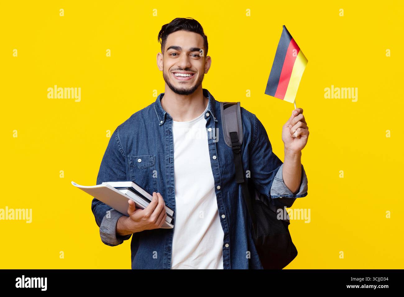 Happy arabic guy student showing flag of Germany Stock Photo - Alamy