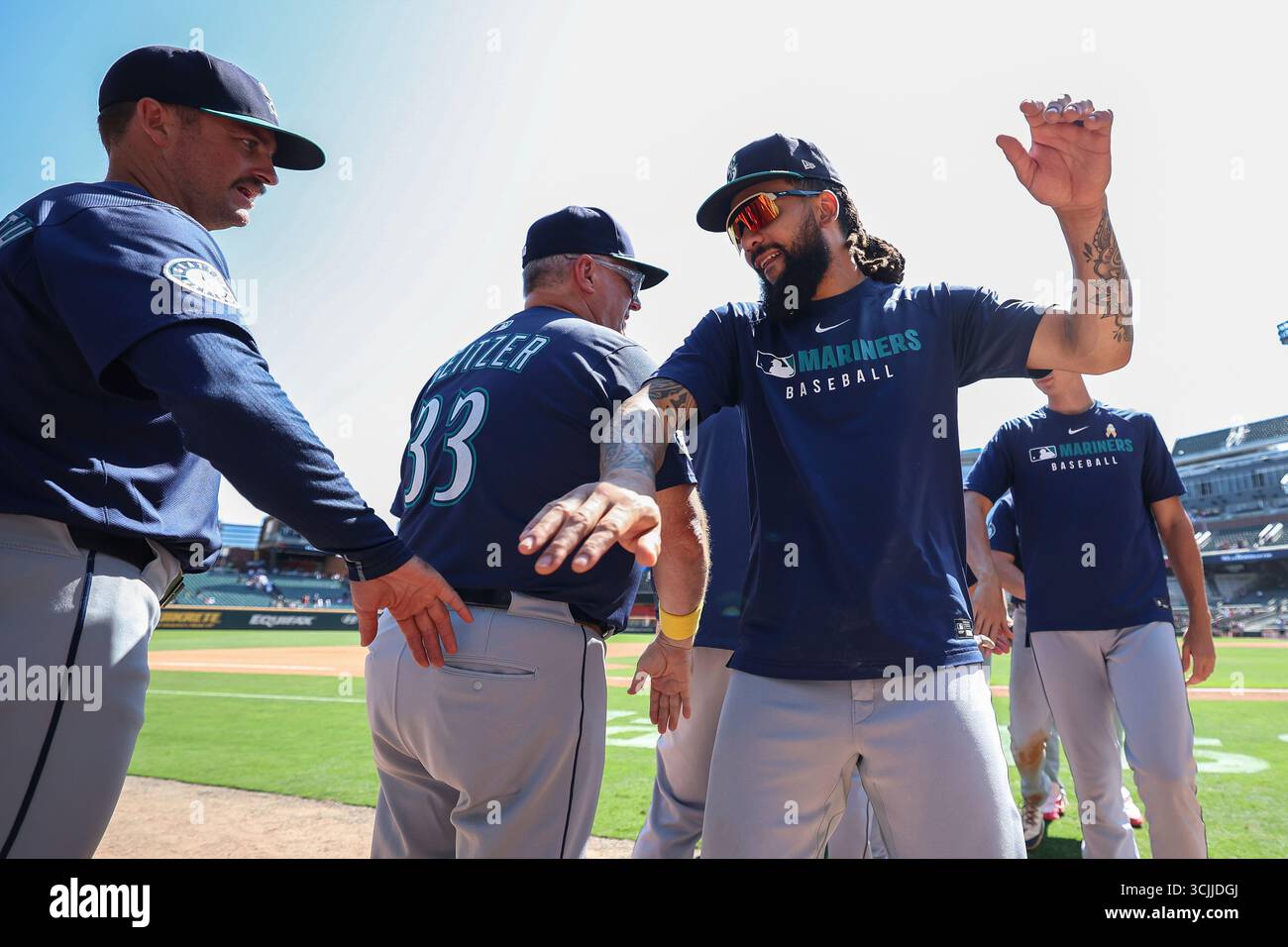 Seattle Mariners' J.P. Crawford high-fives teammates after a baseball ...