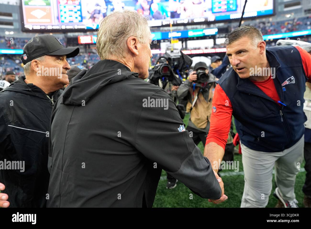 Las Vegas Raiders head coach Pete Carroll, left, meets with New England ...
