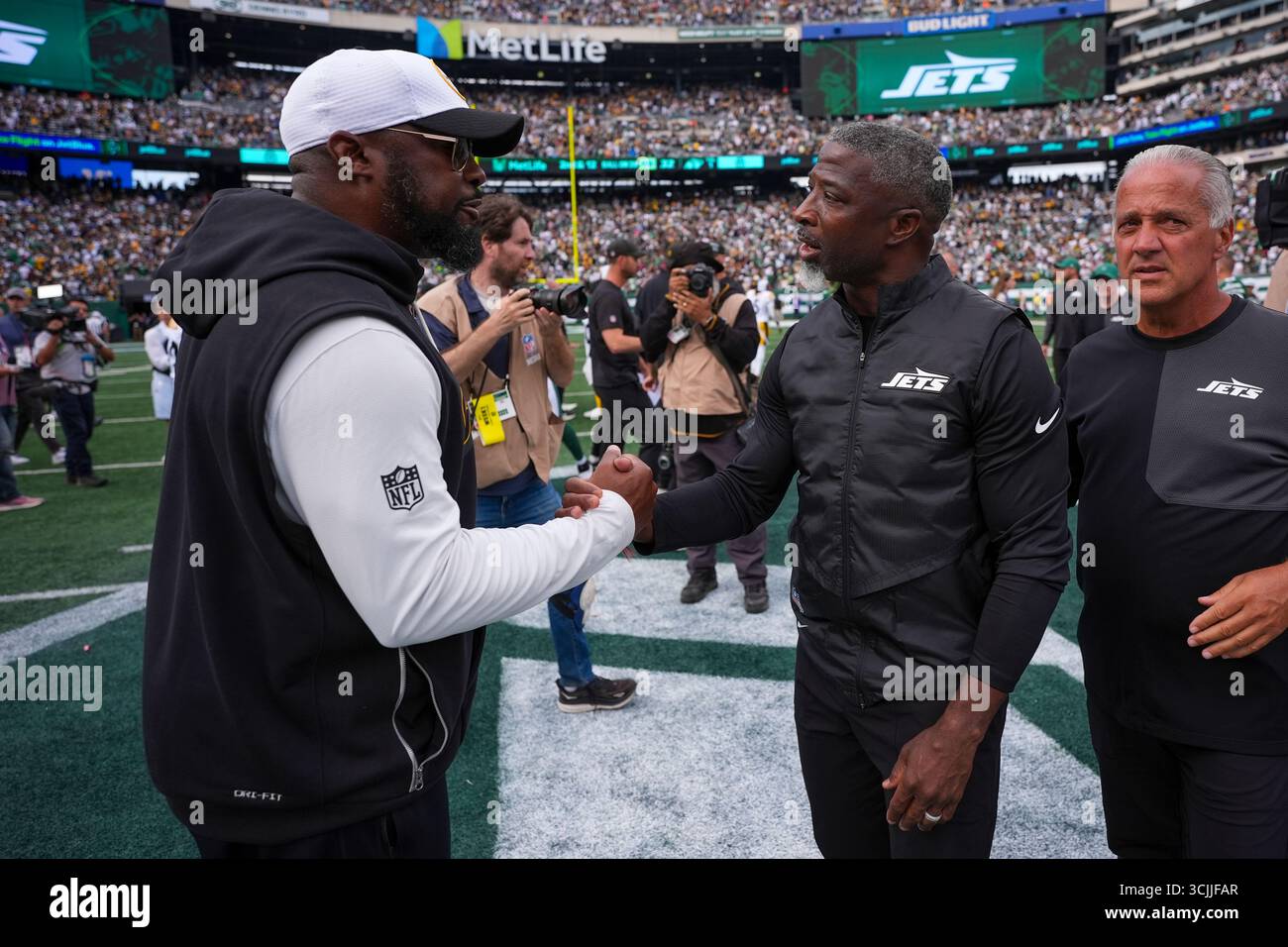 Pittsburgh Steelers head coach Mike Tomlin, left, talks to New York Jets head coach Aaron Glenn ...