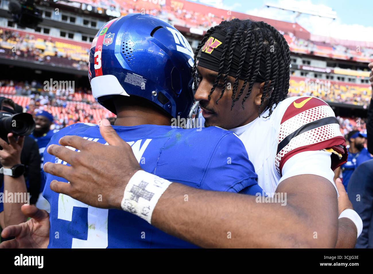 New York Giants quarterback Russell Wilson (3) and Washington Commanders quarterback Jayden ...