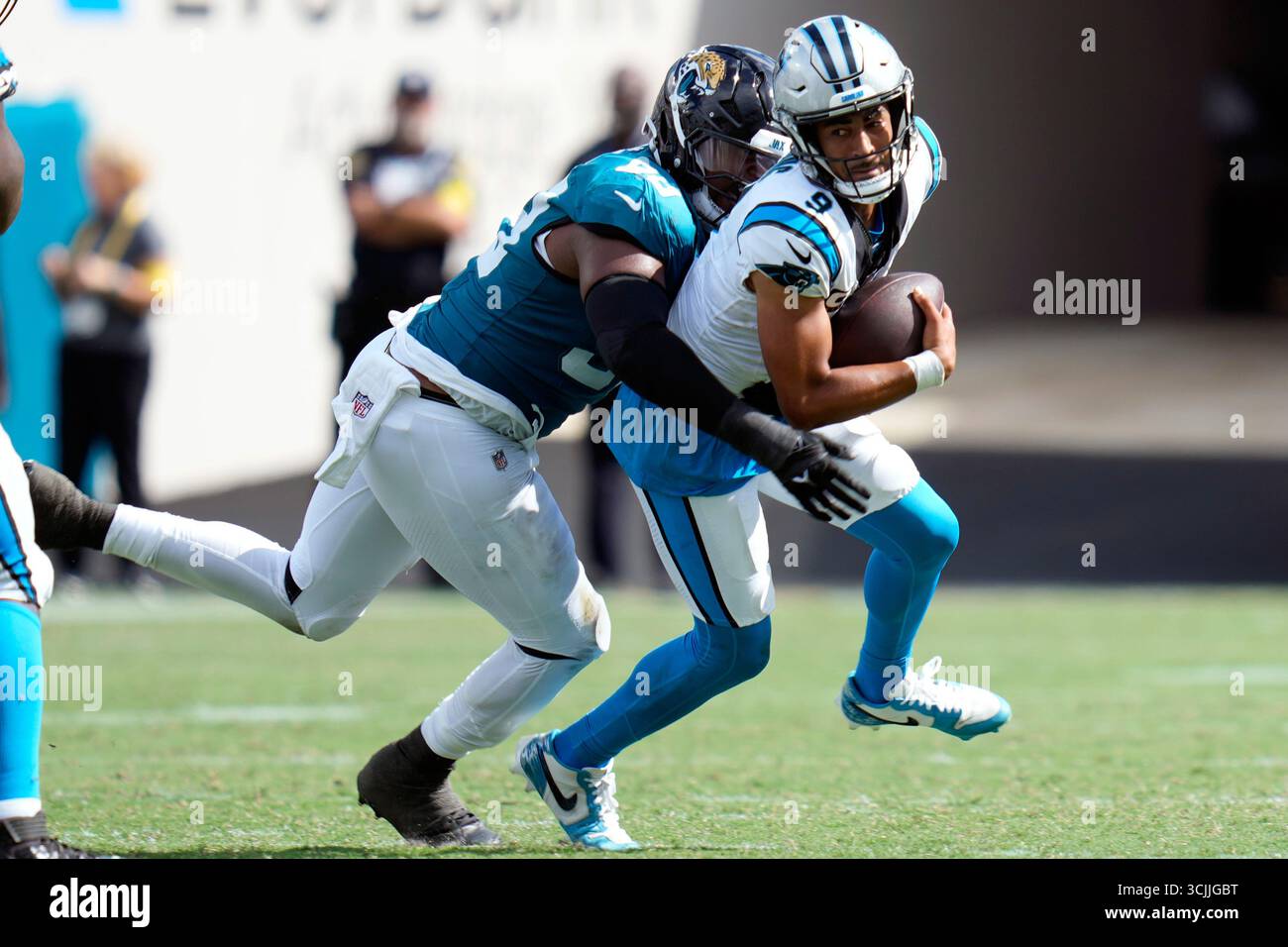 Jacksonville Jaguars defensive end Dawuane Smoot, left, sacks Carolina Panthers quarterback ...