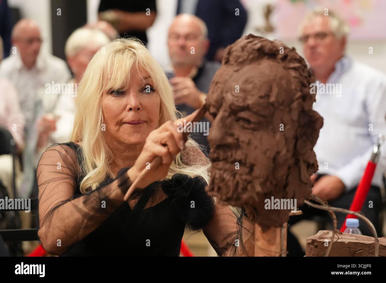 Sculptor Frances Segelman works on a bust of actor Ray Winstone during ...