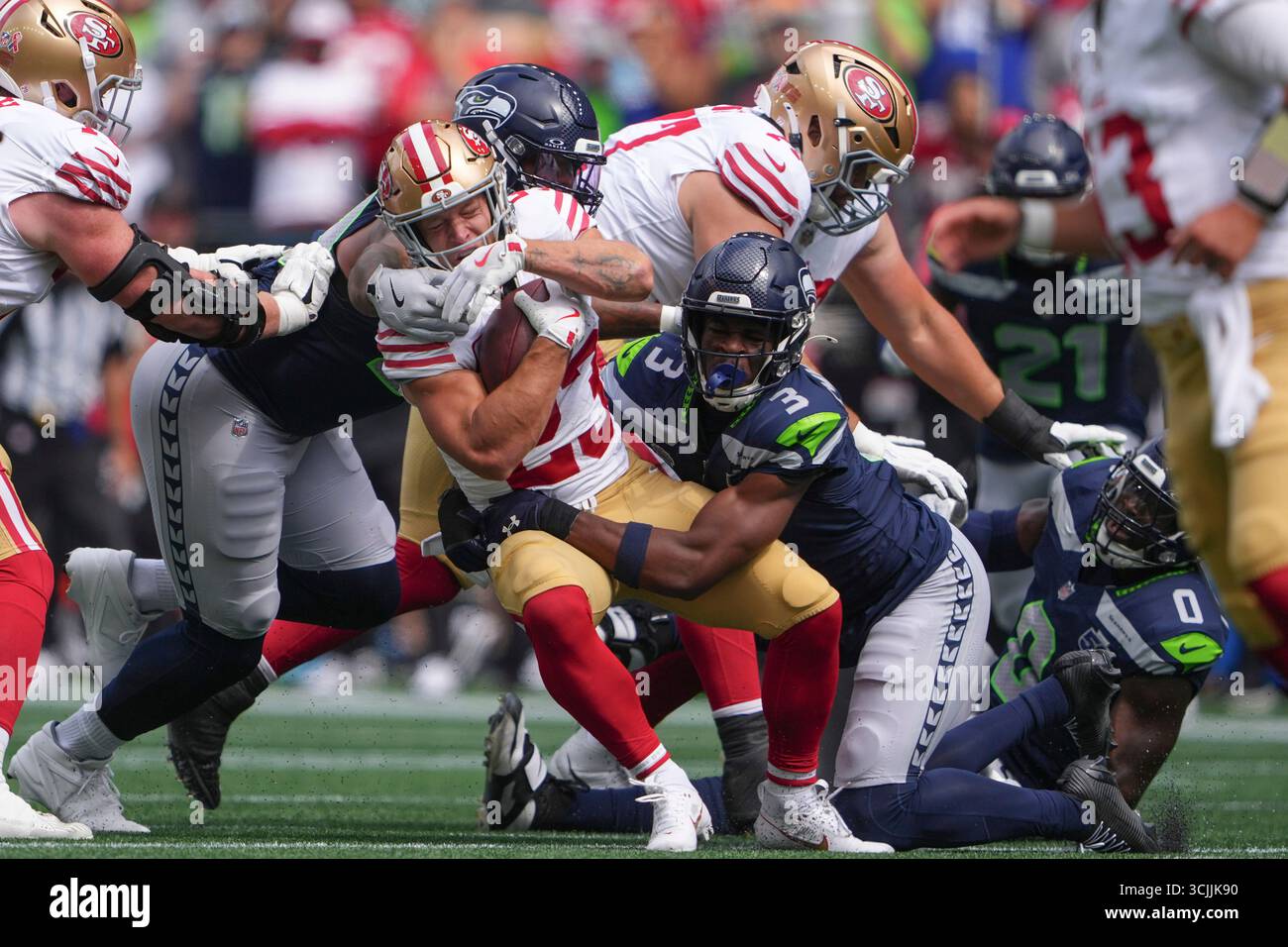 San Francisco 49ers running back Christian McCaffrey (23) holds on to ...