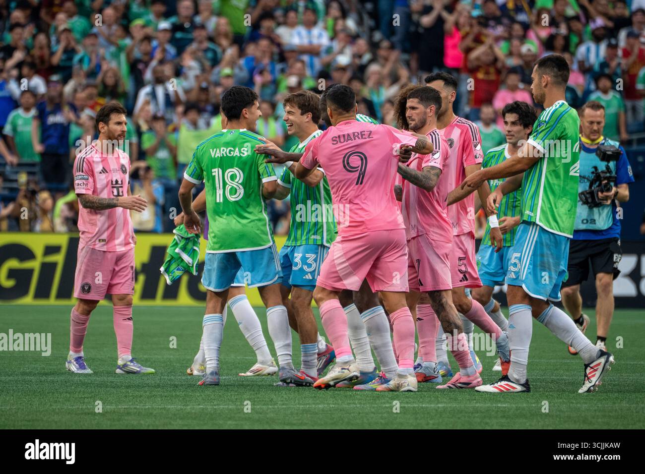 Seattle Sounders FC defender Cody Baker (33) laughs with midfielder ...