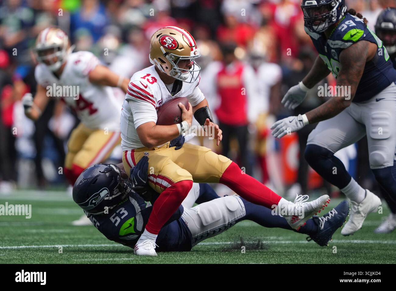 San Francisco 49ers quarterback Brock Purdy (13) is brought down by ...