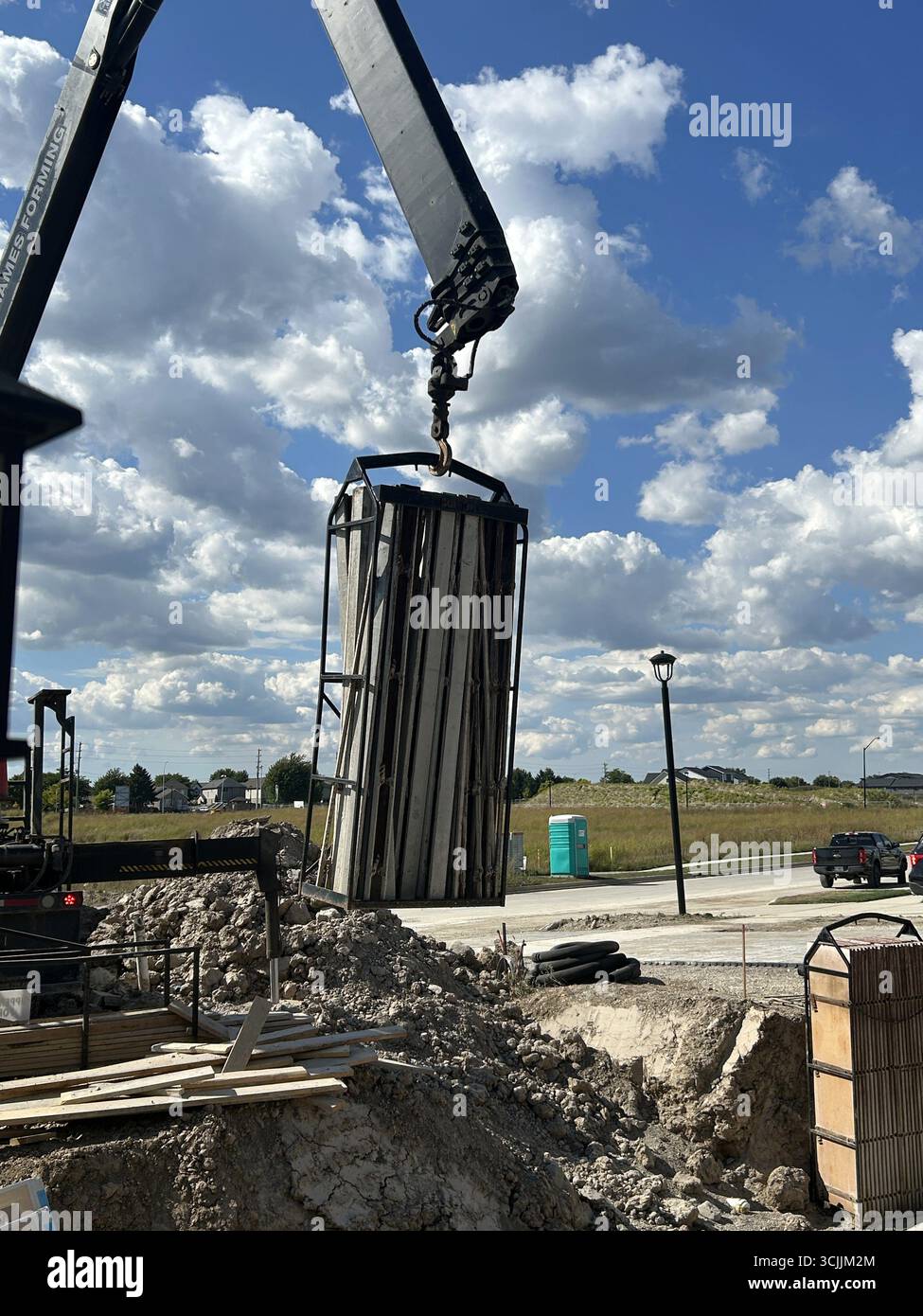 A Crane Lifts a Crate of Precast Concrete Panels Stock Photo - Alamy