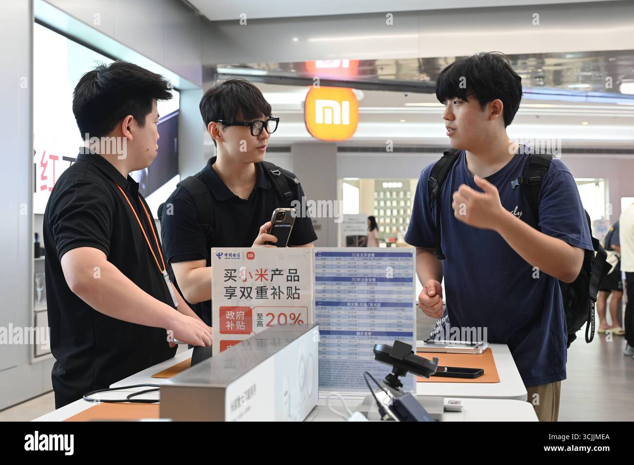 Xiaomi in Shenzhen A man talking about Xiaomi product in the shopping ...