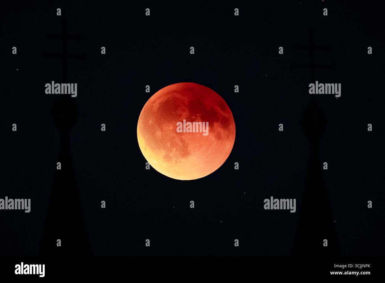 A total lunar eclipse, red (blood) full Moon, over the towers of the ...