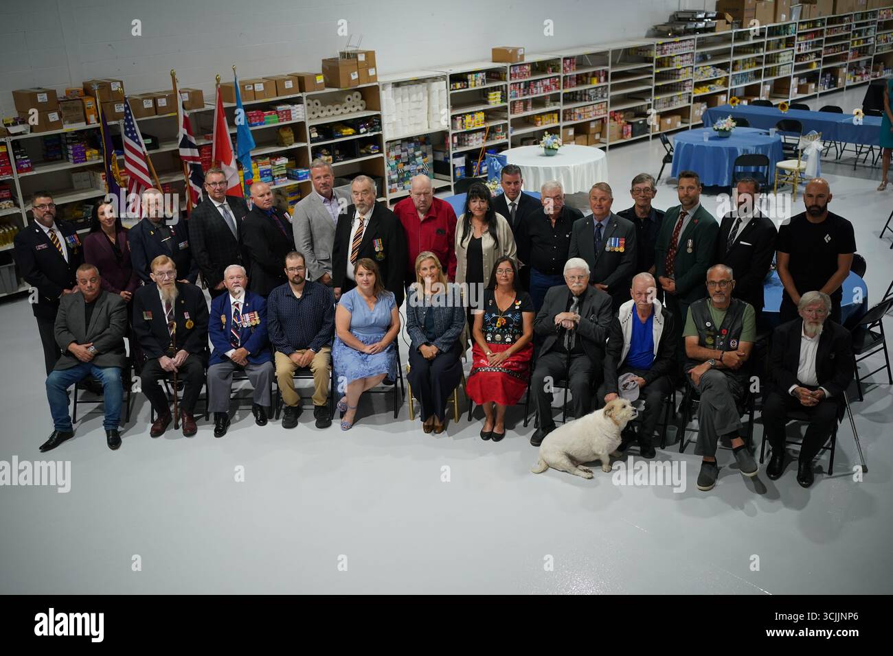 The Duchess of Edinburgh (centre) poses for a photograph with veterans ...