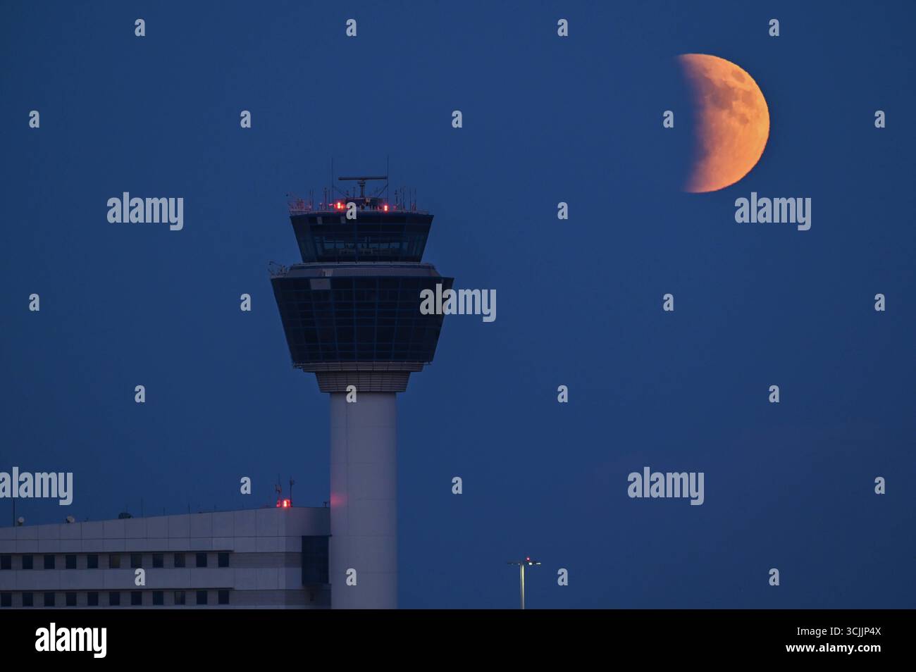 Total lunar eclipse unfolds over the Air Traffic Control Tower at ...