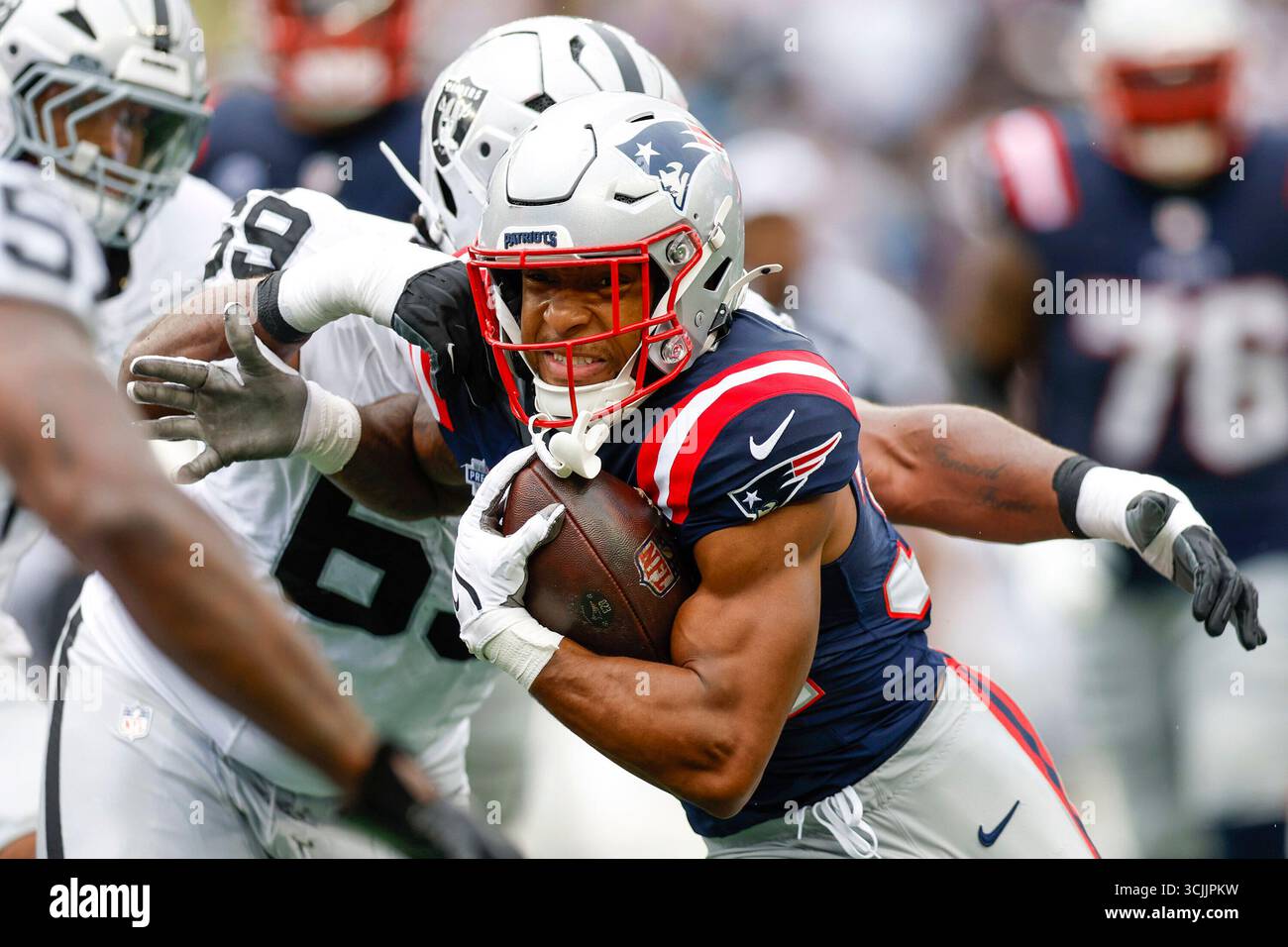 New England Patriots running back TreVeyon Henderson (32) is tackled by ...