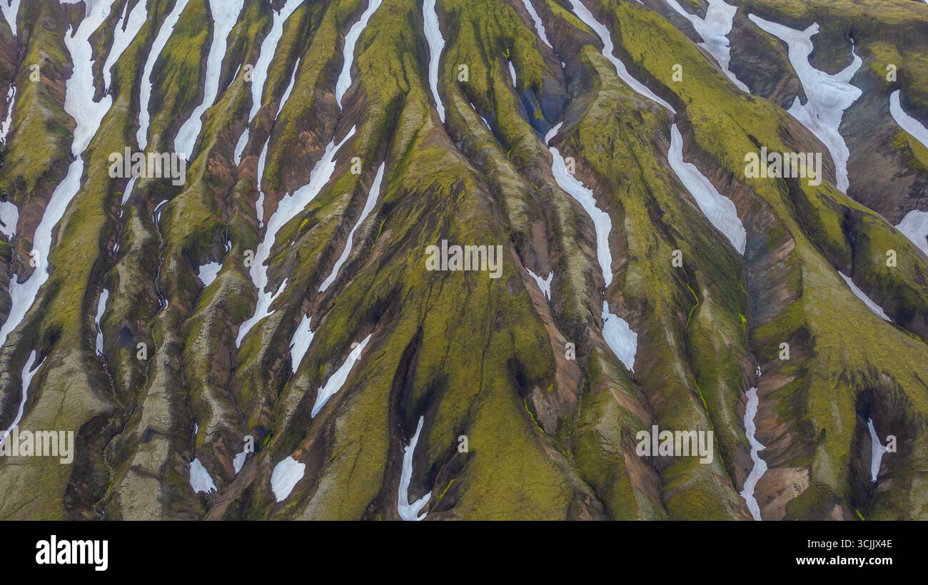 Aerial view of colorful rhyolite mountains in Iceland with snow patches ...