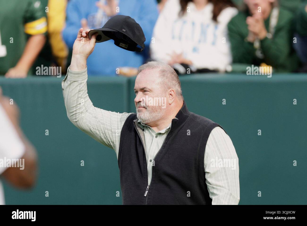 Former Green Bay Packers head coach Mike McCarthy waves during halftime ...