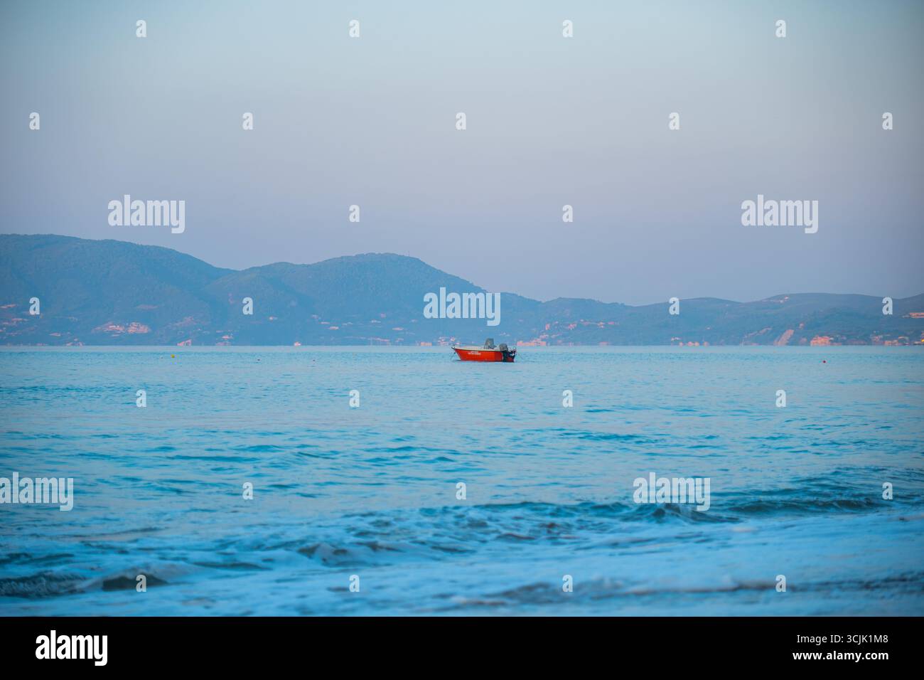 Small red fishing boat floating on calm blue sea near Kalamaki Beach ...