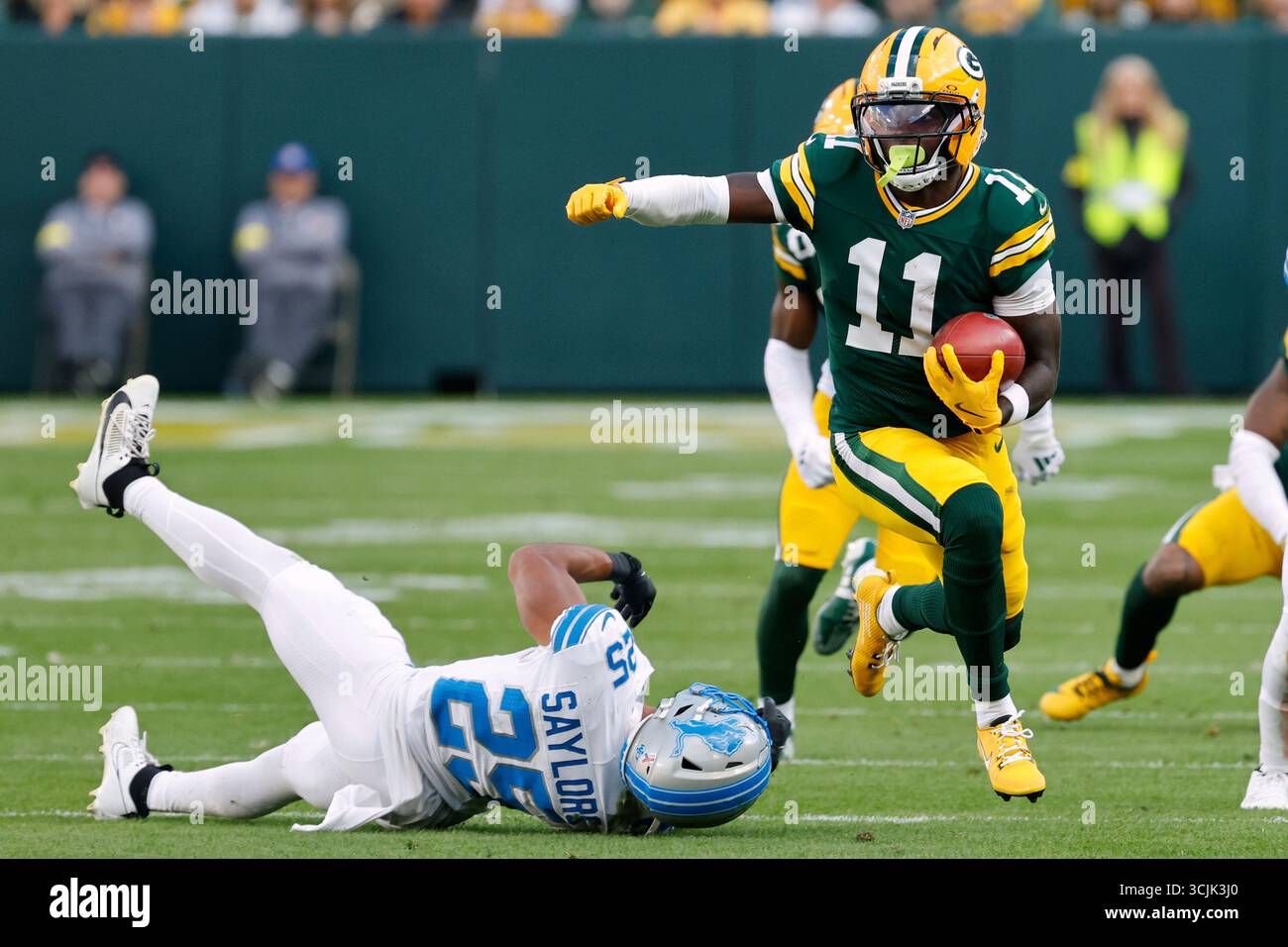 Green Bay Packers' Jayden Reed (11) runs past Detroit Lions' Jacob ...