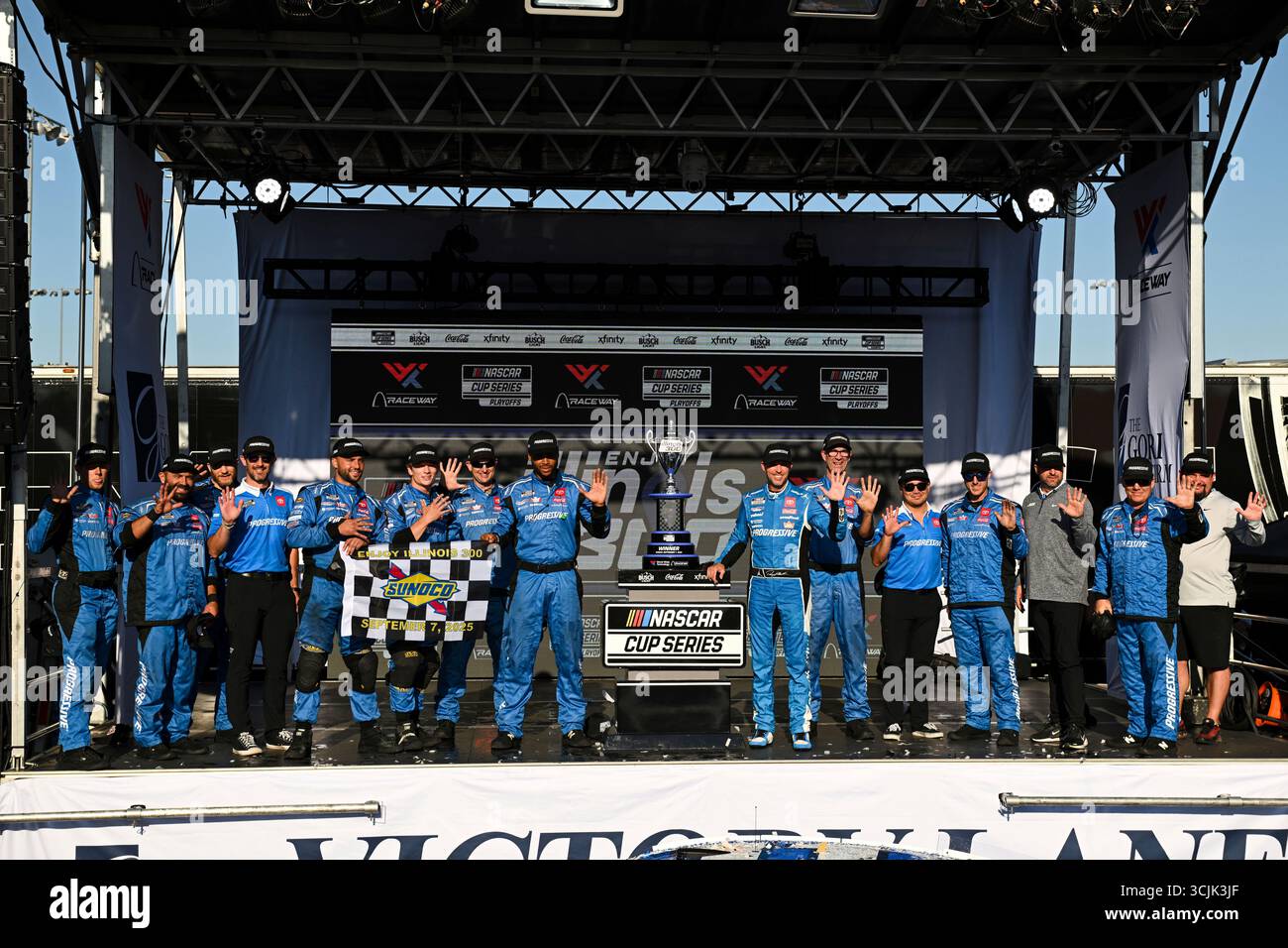 Denny Hamlin, center right, celebrates after winning a NASCAR Cup ...