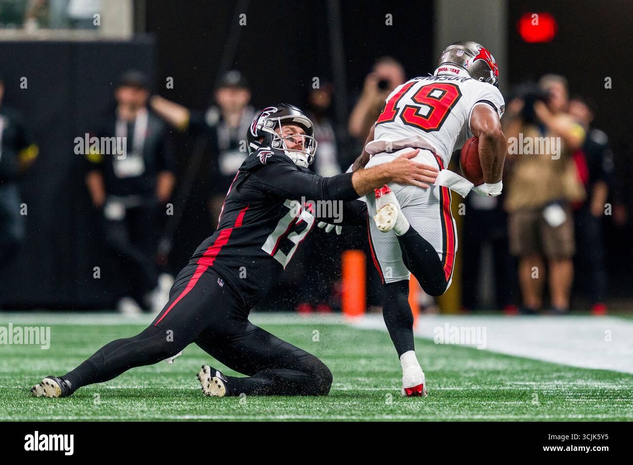 Atlanta Falcons punter Bradley Pinion (13) grabs on to Tampa Bay Buccaneers wide receiver ...