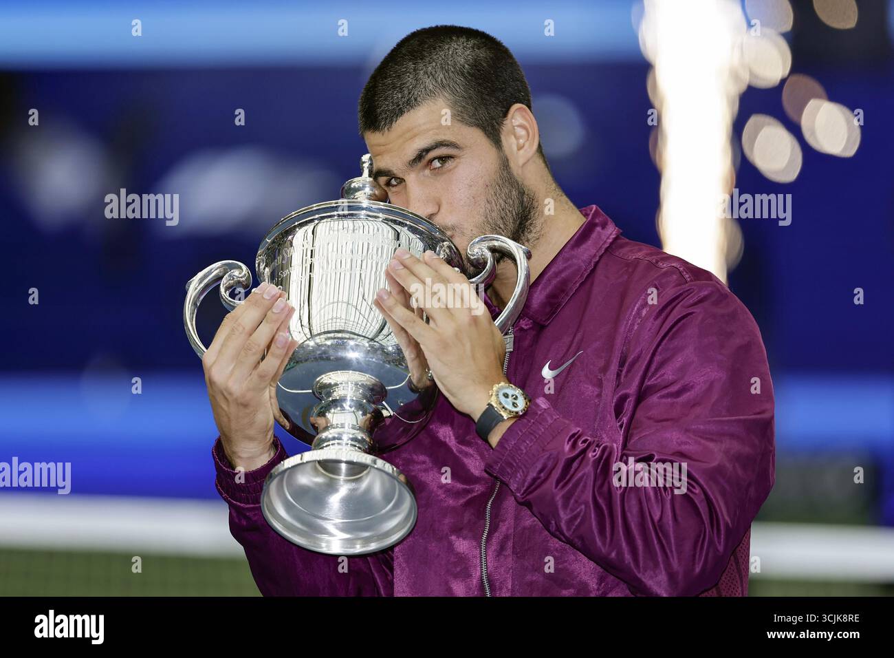 Carlos Alcaraz of Spain kisses the victor's trophy after winning the ...