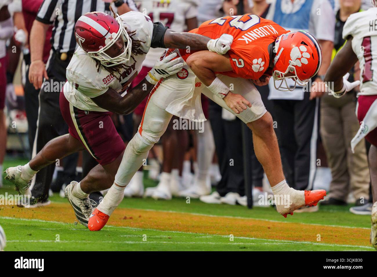 Troy linebacker Jordan Stringer (7) tackles Clemson quarterback Cade ...