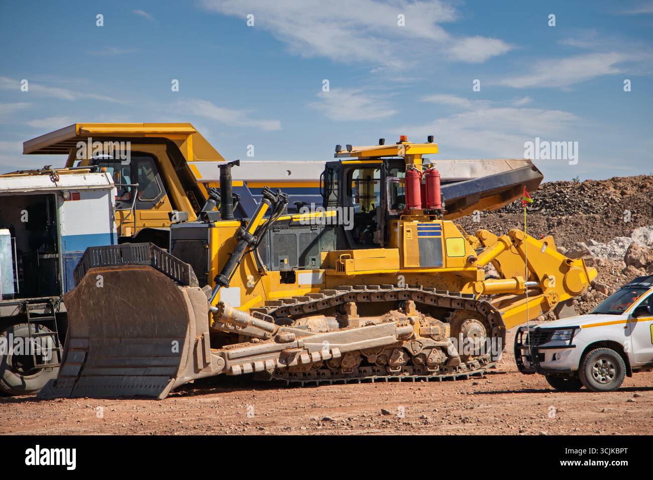 mining truck, bulldozer and a pick-up at a mechanical mobile workshop ...