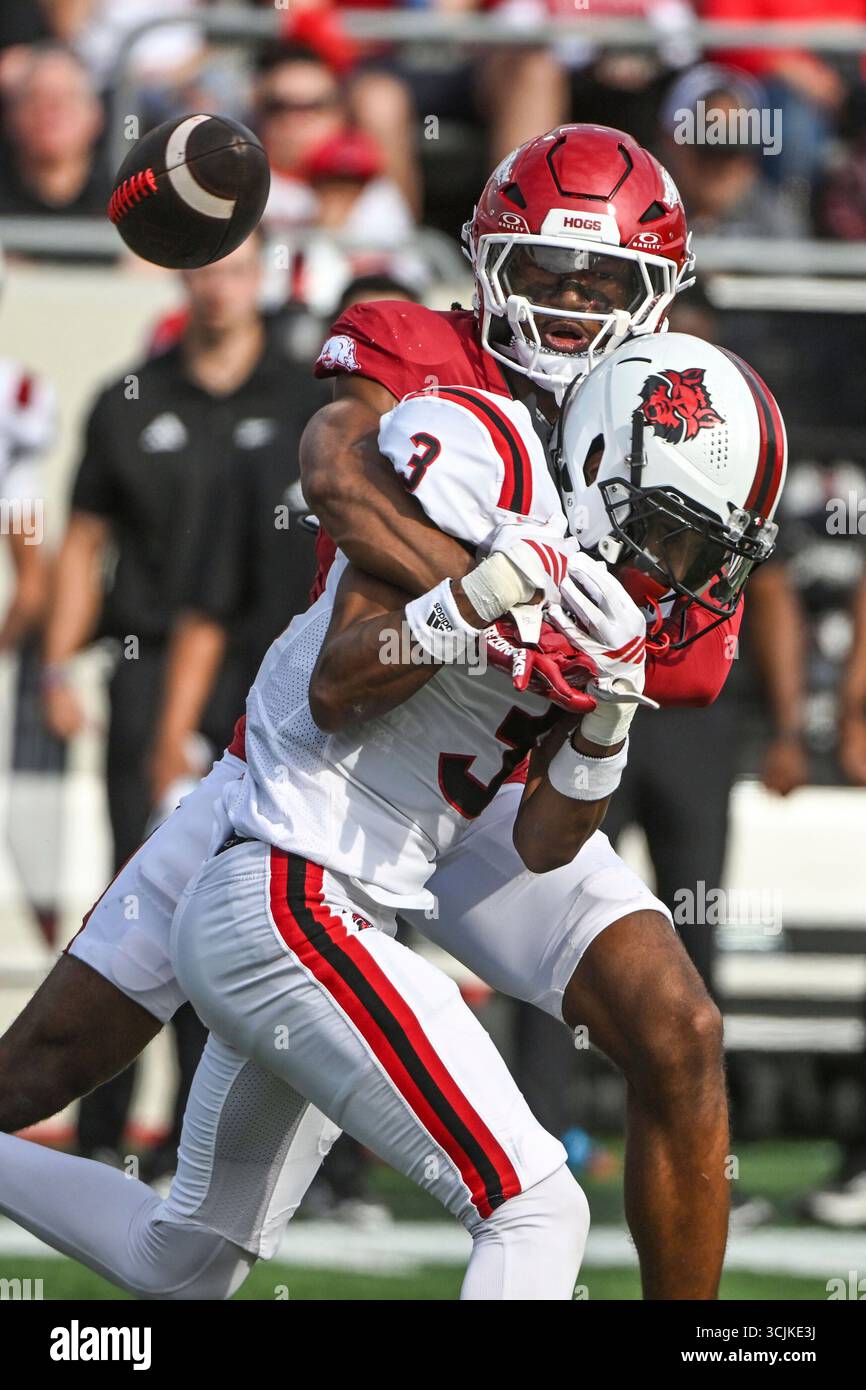 Arkansas defensive back Kani Walker (13) breaks up a pass intended for ...