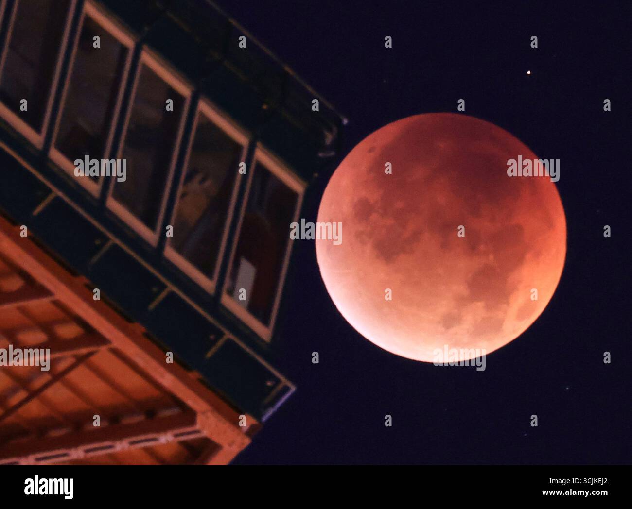 A total lunar eclipse is observed beside the Sapporo TV Tower in Sapporo City, Hokkaido ...