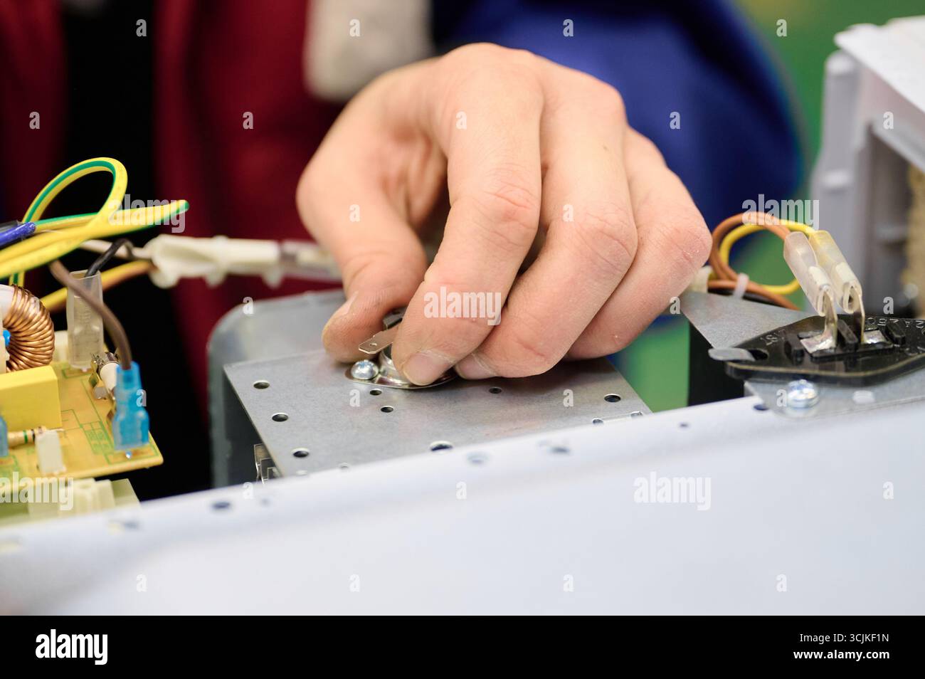 Assembly process of microwave oven electrical components on conveyor ...