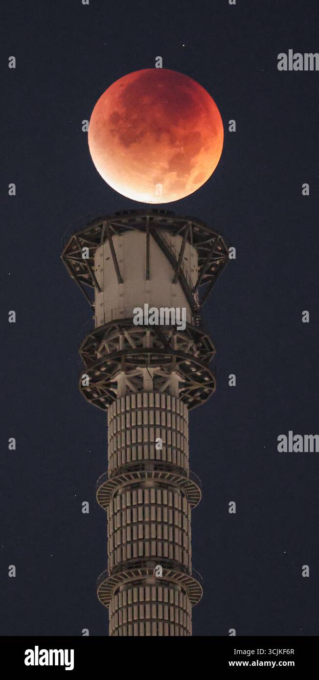 A total lunar eclipse is observed above the Tokyo Skytree in Tokyo on ...