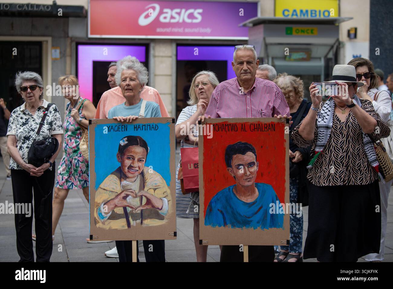 Protesters hold placards with the faces of Palestinian children during ...