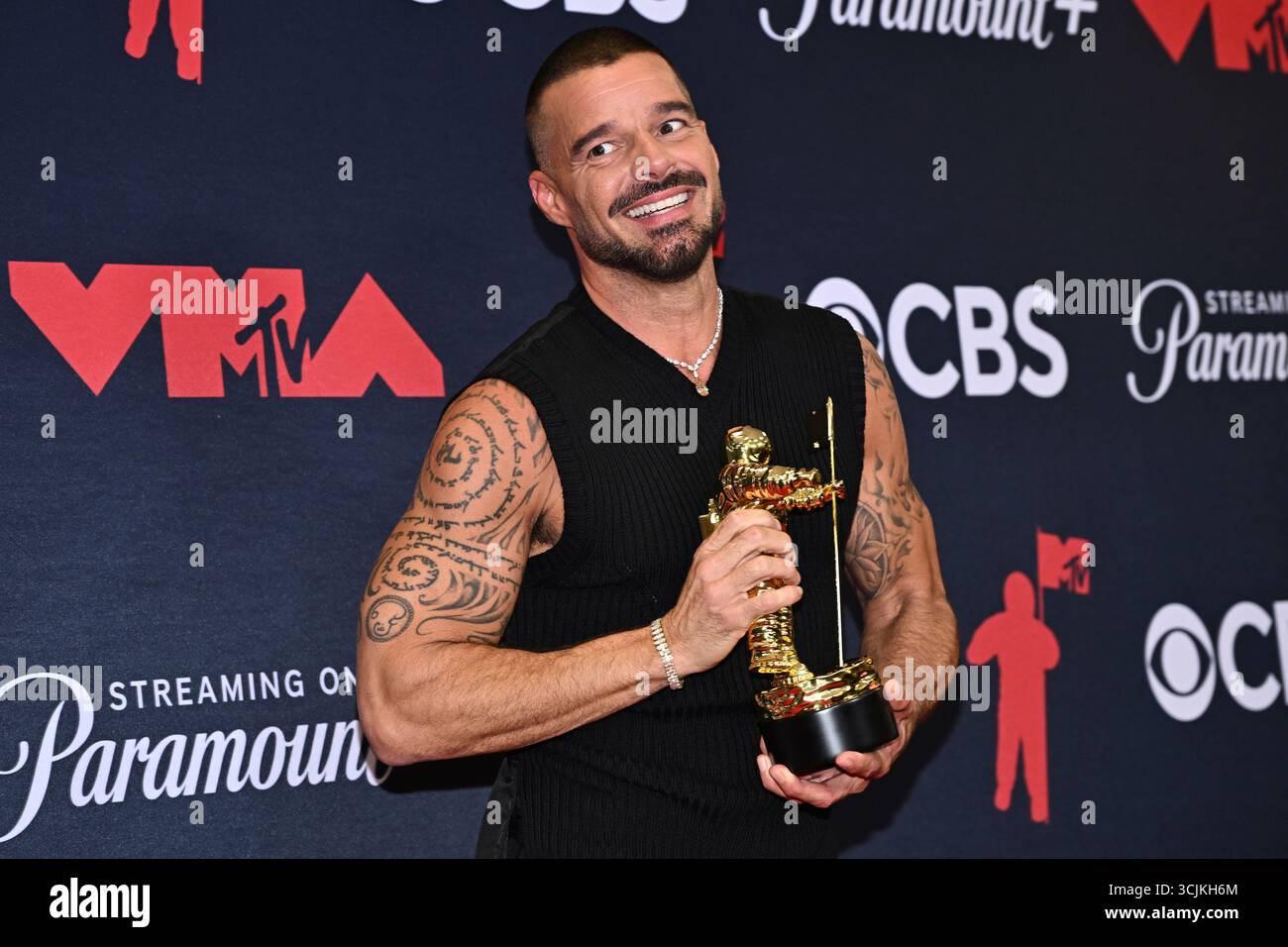 Ricky Martin, winner of the latin icon award, poses in the press room ...