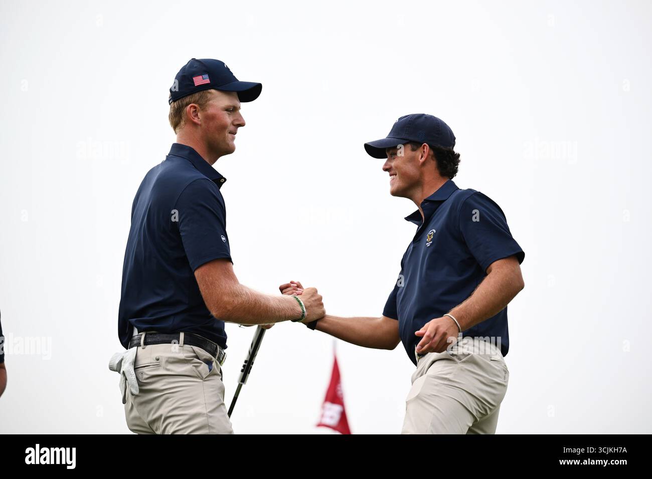 The USA team's Tommy Morrison, left, shakes hands with Jackson Koivun ...