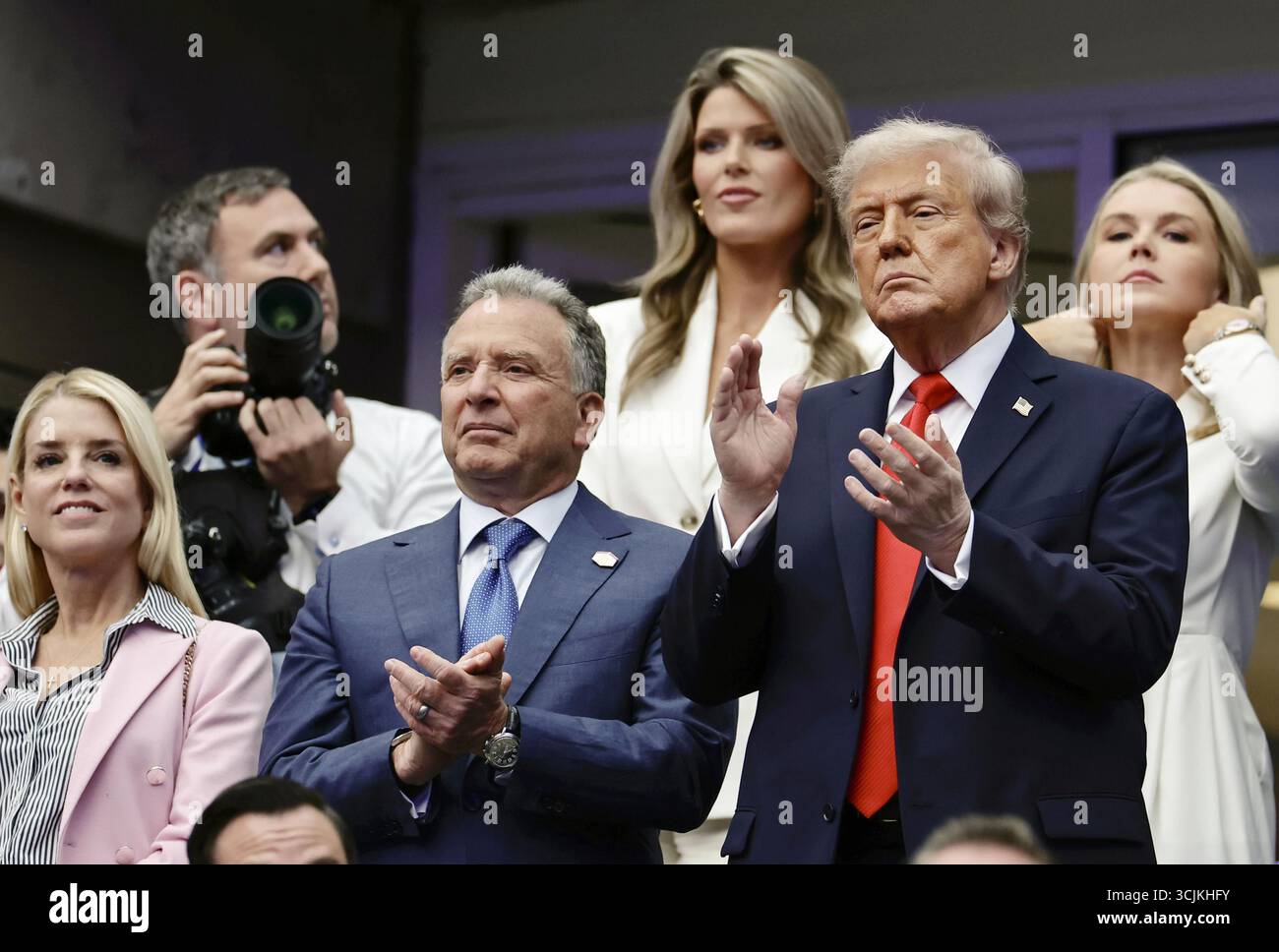 U.S. President Donald Trump (front row, R) applauds during a ceremony ...
