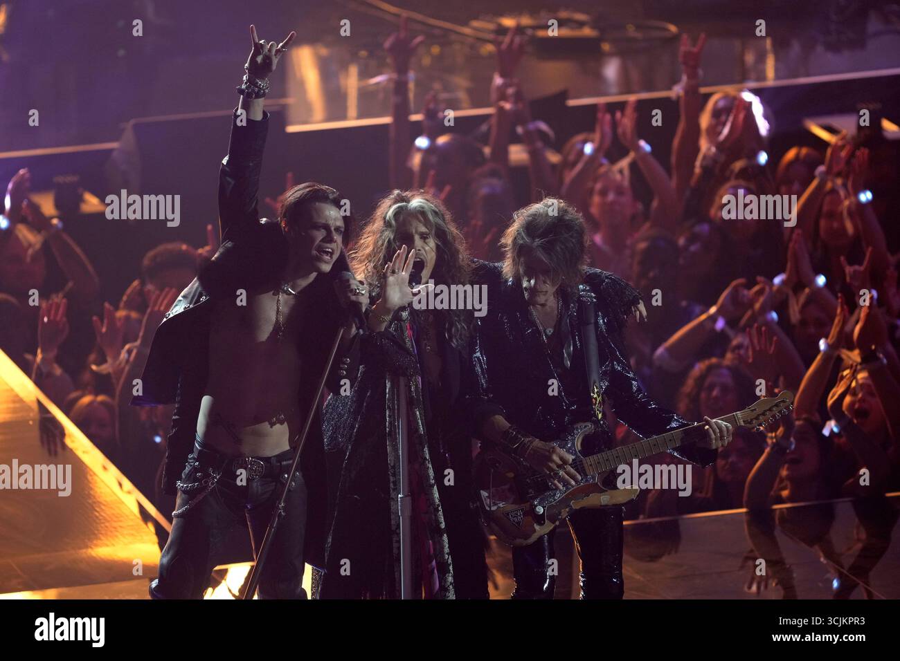 Yungblud, from left, Steven Tyler, and Joe Perry perform a tribute to Ozzy Osbourne during the ...
