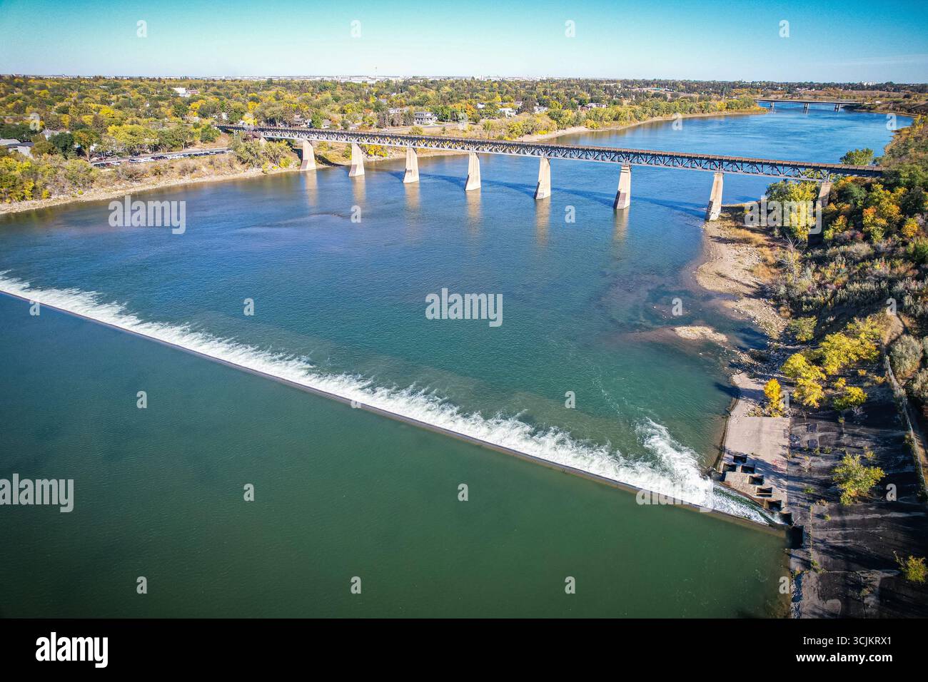 Bridge spans a river with a large body of water on either side. The ...