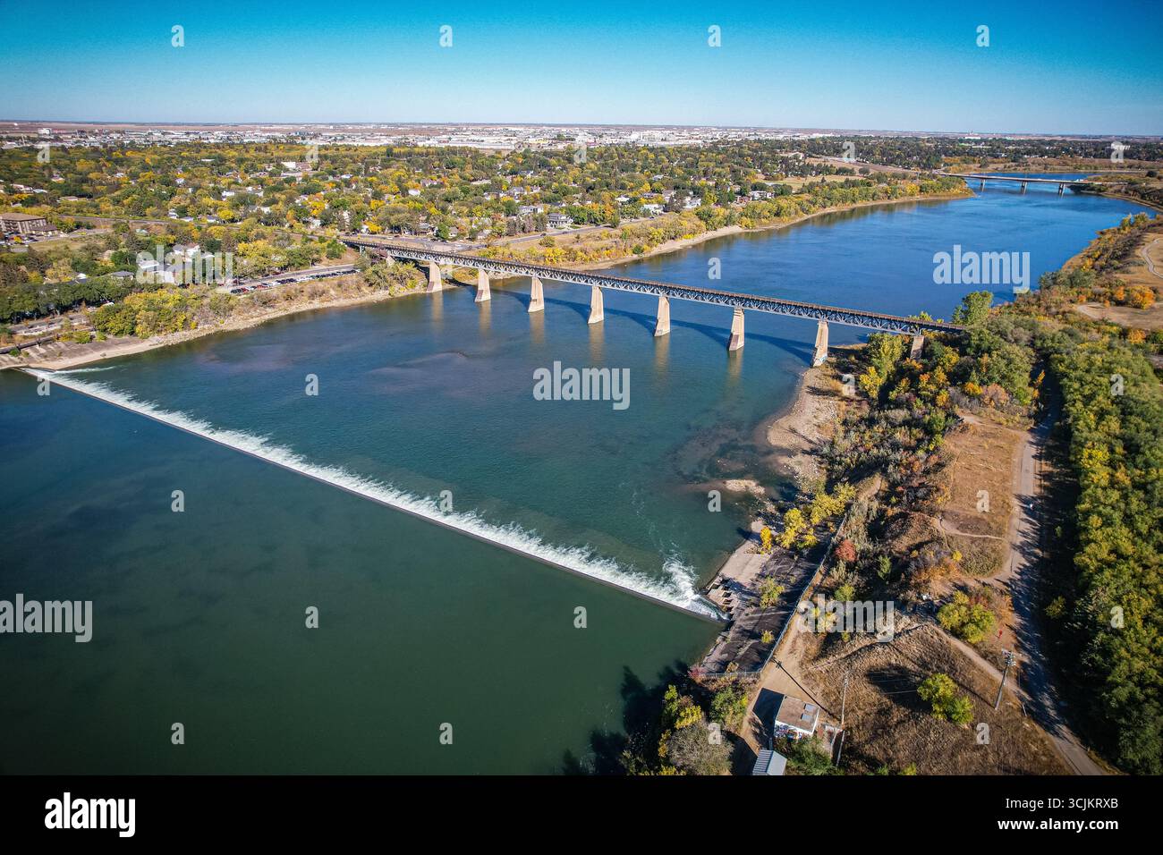 Bridge spans a river with a green waterway below. The bridge is ...
