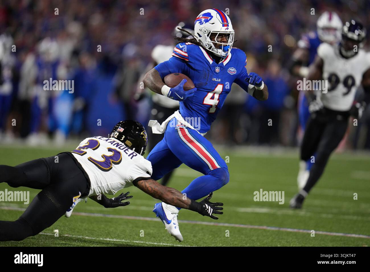 Buffalo Bills running back James Cook (4) runs past Baltimore Ravens ...