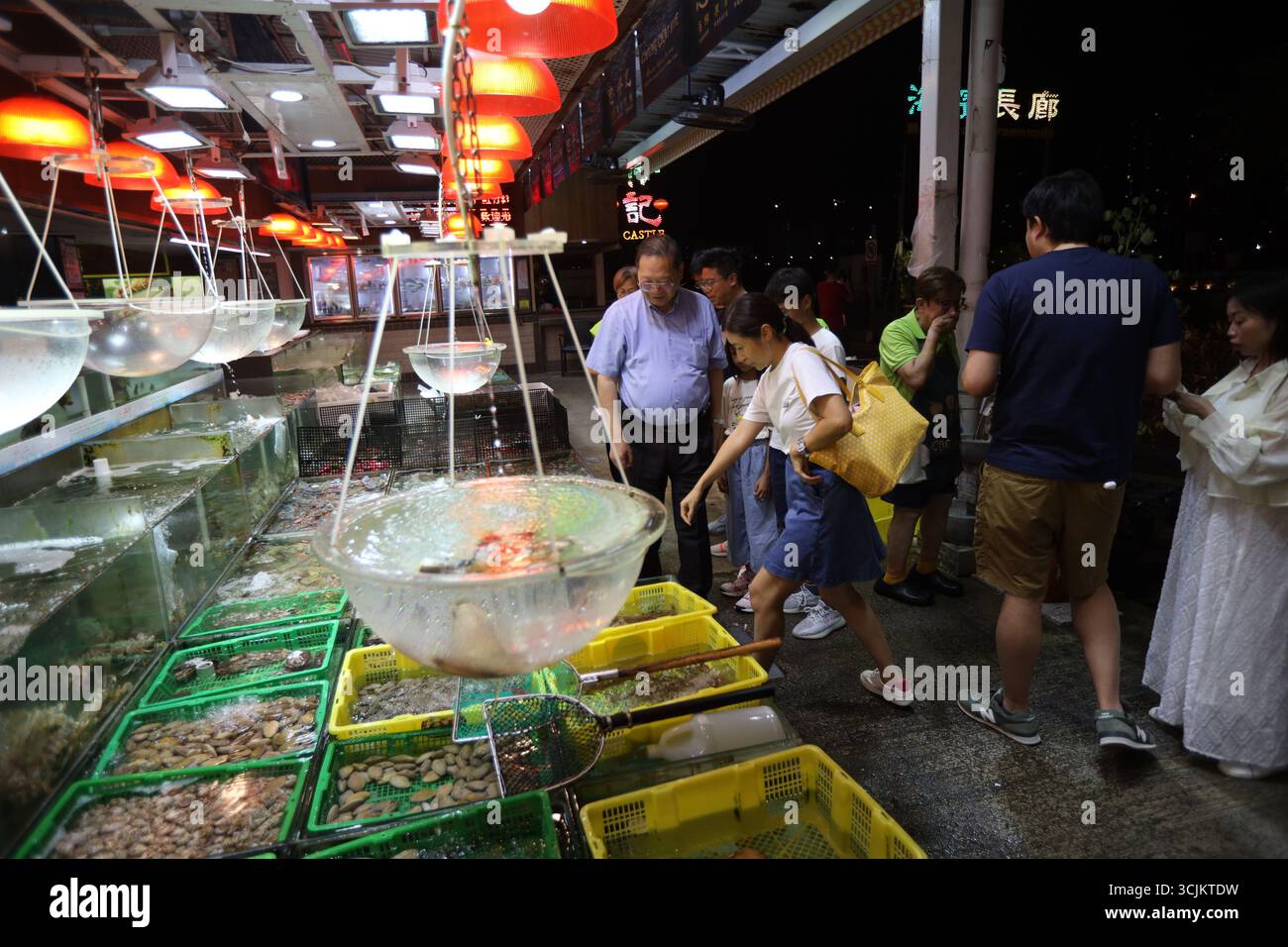 People buy seafood at seafood shops in Sam Shing Estate, Tuen Mun on ...