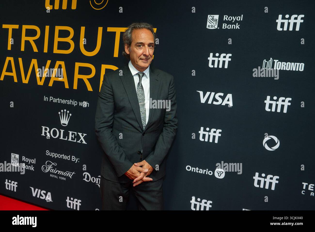 Alexandre Desplat arrives on the red carpet for the TIFF Tribute Awards ...