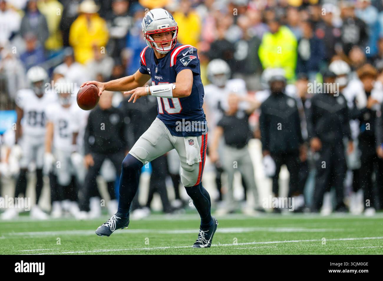 New England Patriots quarterback Drake Maye (10) rolls out of the pocket during the first half ...