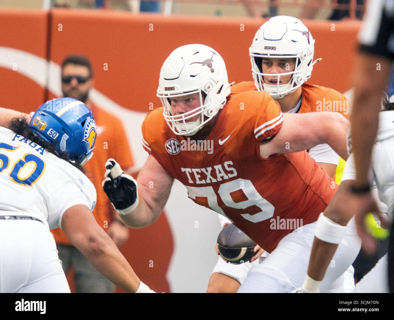 Texas offfensive lineman Connor Stroh , center, blocks for Texas ...