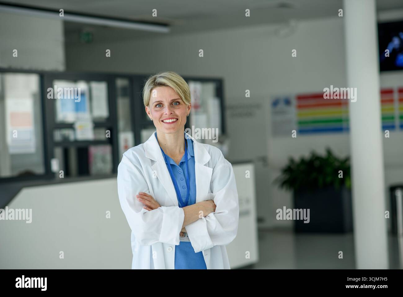 Young female doctor with short hair in hospital corridor Stock Photo ...