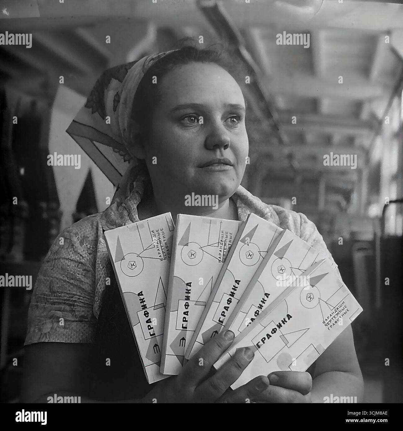 A happy female worker at the Slavyansk Pencil Factory proudly displays ...