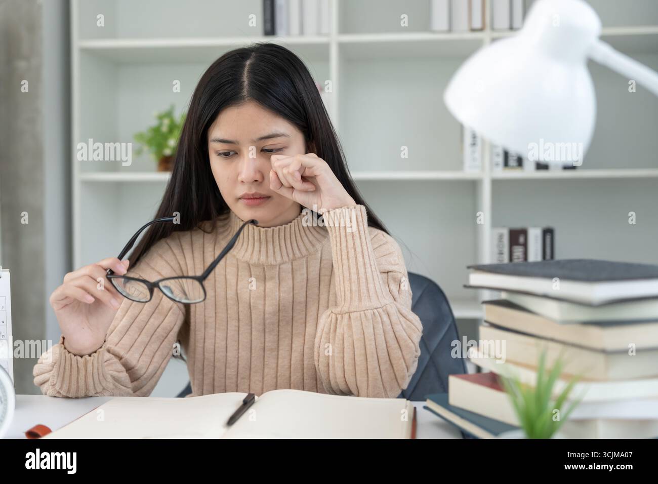 Eye problems, Asian women with tired and irritated eyes, eye rubbing ...