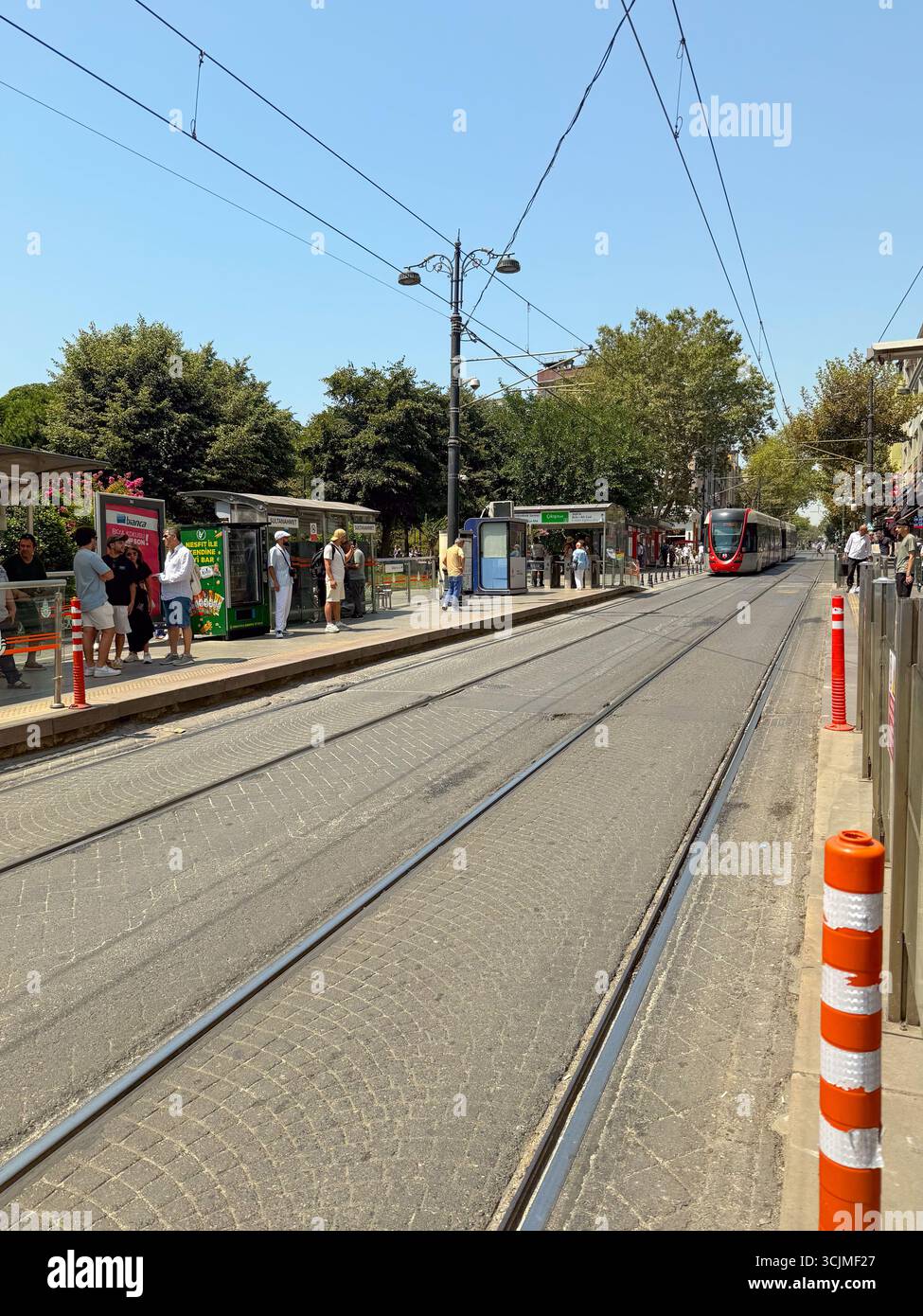 Modern tram arriving at Sultanahmet station with passengers waiting ...
