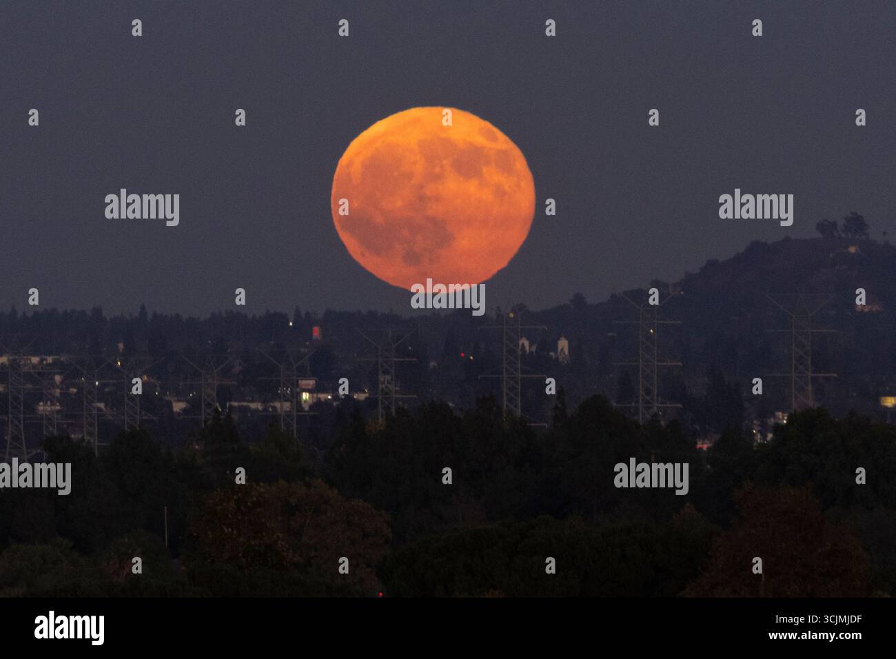 The full moon, also known as the Corn Moon, rises in the sky in Los ...