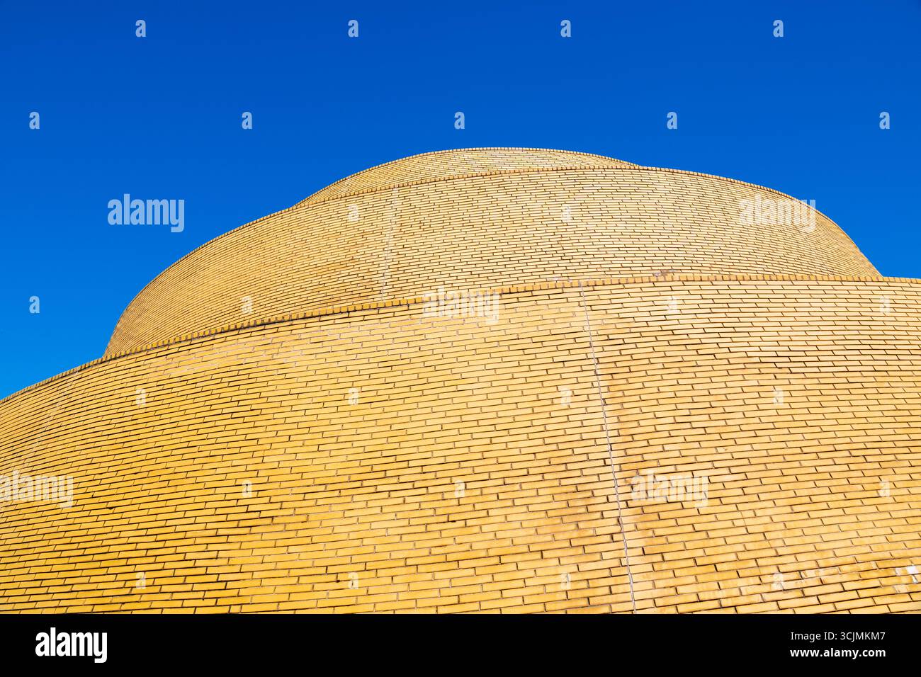 Budapest Ziggurat dome with layered yellow brick structure against deep ...