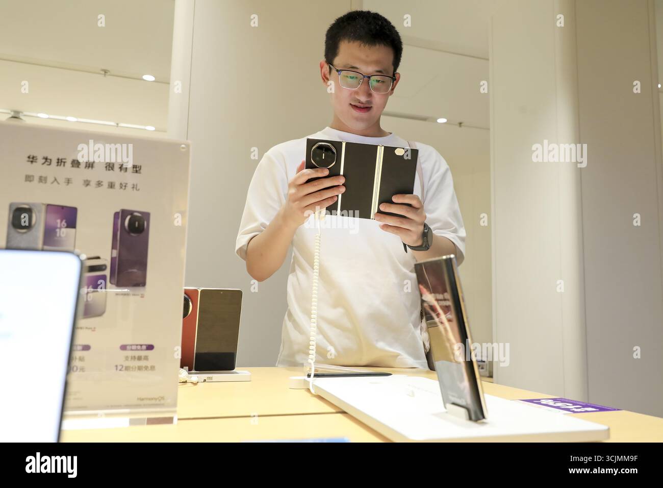 Huawei's tri-fold phone Huawei Mate XTs attracts customers at a Huawei ...
